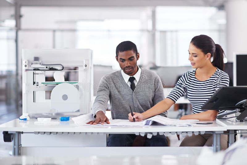 Working on Something Innovative. Two Colleagues Talking Together Over a ...