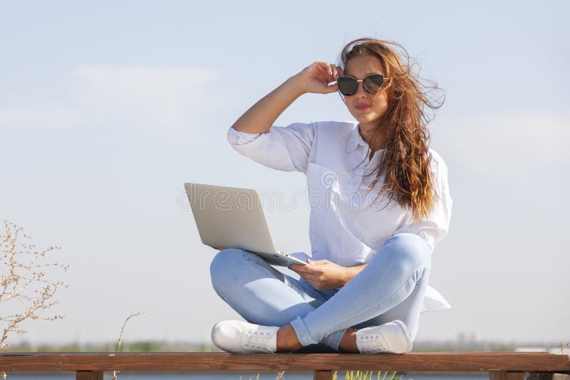 Working on Something with a Laptop in a Public Park Stock Photo - Image ...