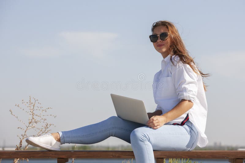 Working on Something with a Laptop in a Public Park Stock Photo - Image ...