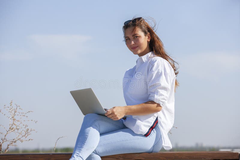 Working on Something with a Laptop in a Public Park Stock Photo - Image ...