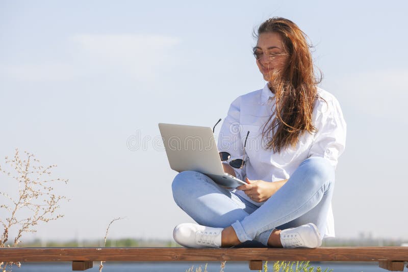 Working on Something with a Laptop in a Public Park Stock Photo - Image ...