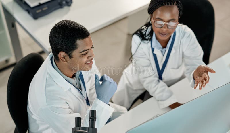 Working on Something New. Two Scientists Working Together on a Computer ...