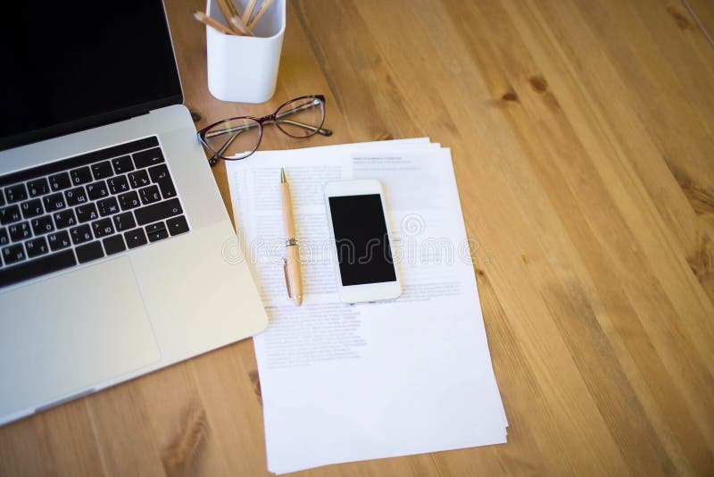 Working Space with Open Laptop Computer, Modern Mobile Phone and Paper ...