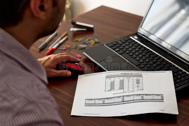 Working on a Spreadsheet with a Computer and Office Supplies Stock ...