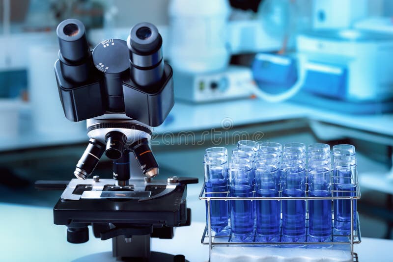 Microscope and Rack with Sample Tubes in the Microbiology Laboratory ...