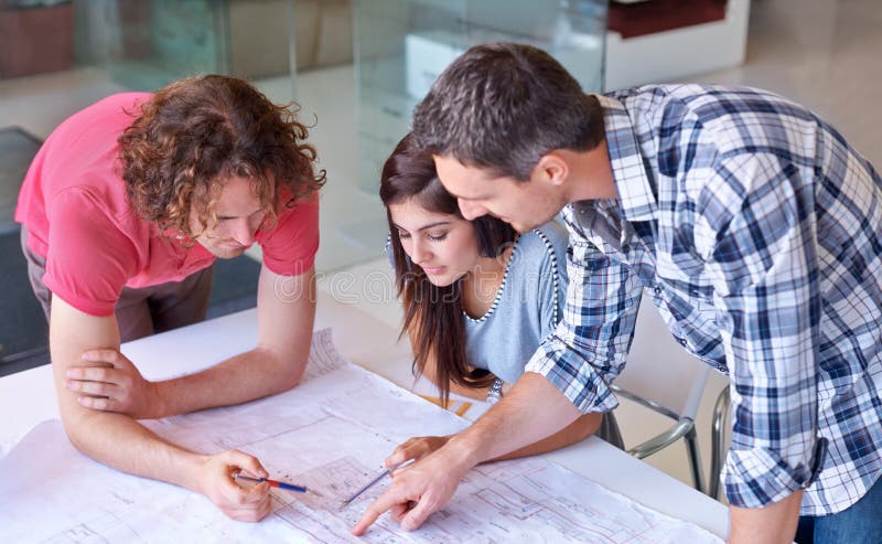 Working on Their Blueprints - Architecture. Three Architects Working on ...