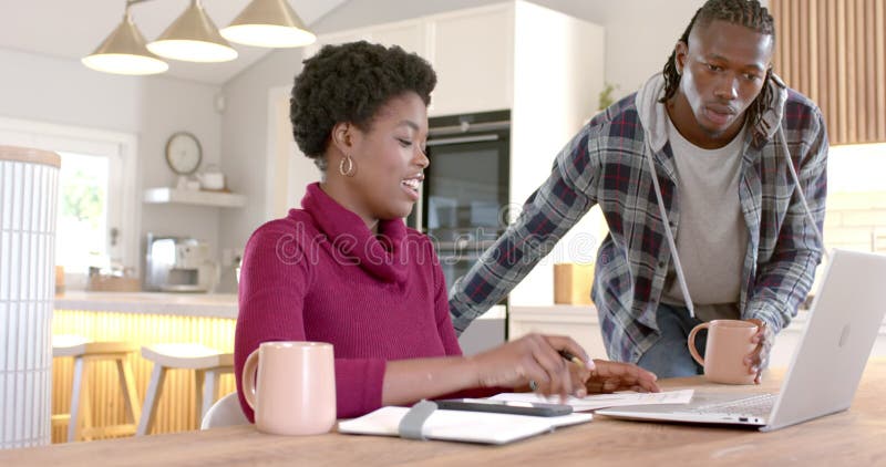 Working Together, African American Couple Using Laptop and Discussing ...