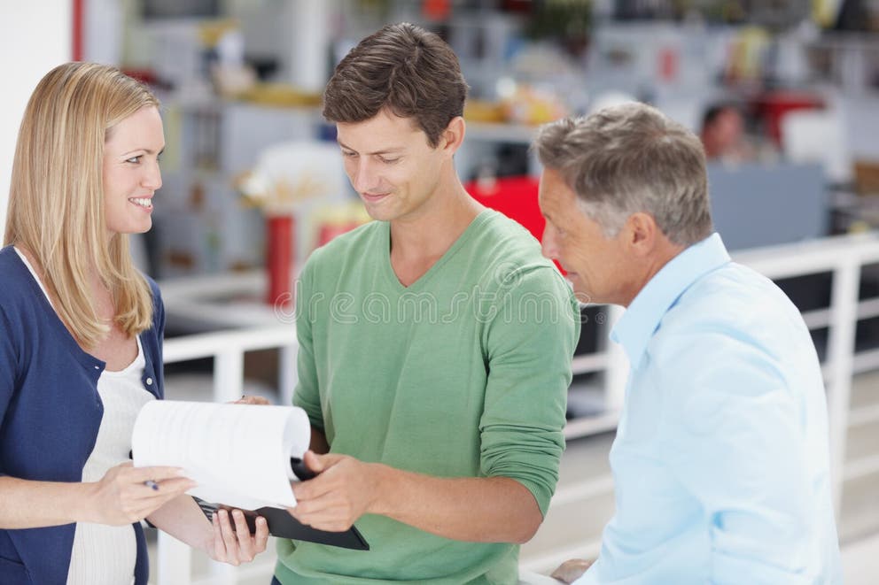 Working Together As a Team. Three Work Colleagues Discussing Something ...