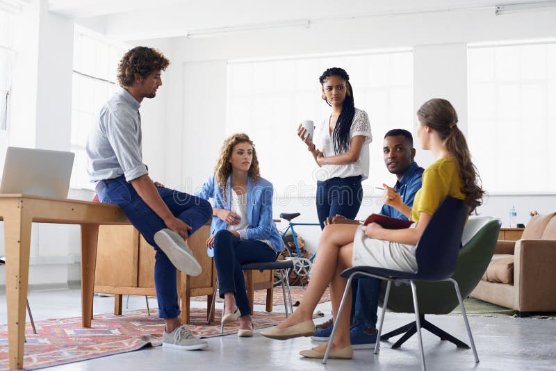 Working Together for Better Results. Young People Chatting in the ...