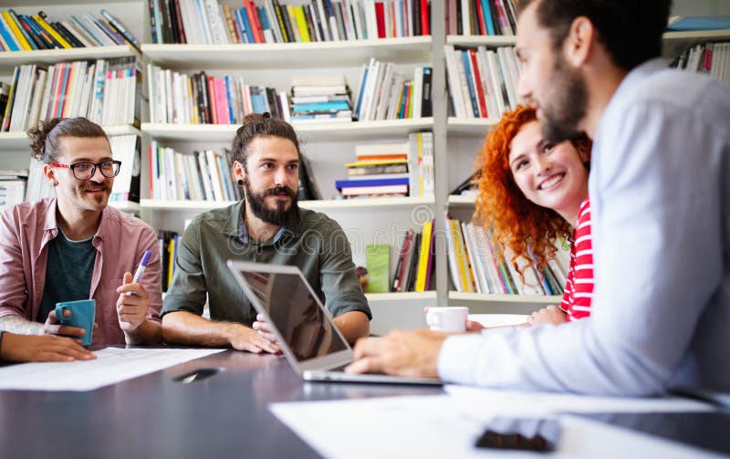 Working Together on Project. Happy Young Business Colleagues Working in ...