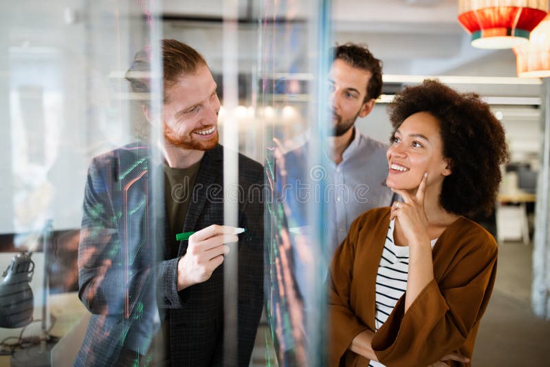 Working Together on Project. Happy Young Business Colleagues Working in ... Working Together on Project. Happy Young Business Colleagues Working in ...