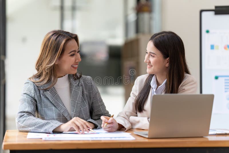 Working Together on Project. Two Young Asian Business Colleagues ...