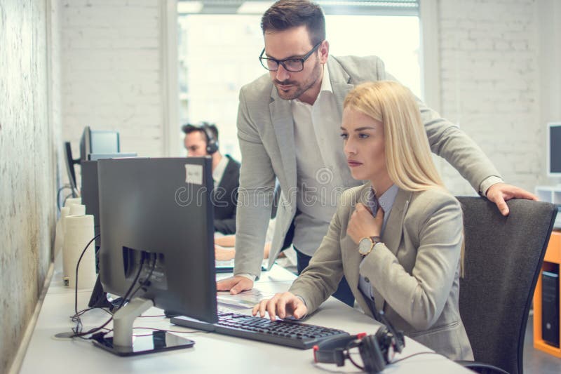 Working Together on Project. Two Young Business Colleagues Working on ... Working Together on Project. Two Young Business Colleagues Working on ...