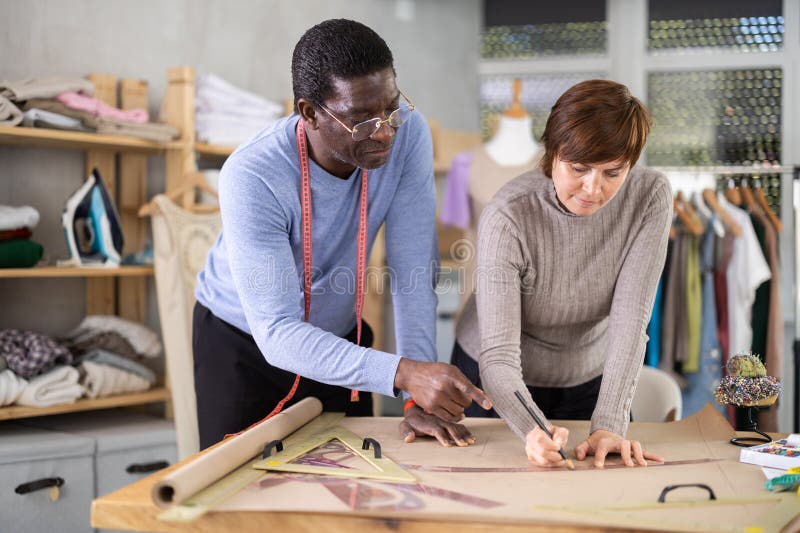 Two Dressmakers Sketching Garment Pattern on Paper in Sewing Studio ...