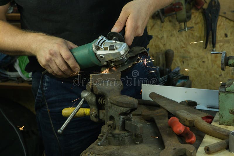 Working with the Tool. Hands of a Young Man Working with a Grinder ...