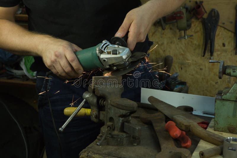 Working with the Tool. Hands of a Young Man Working with a Grinder ...