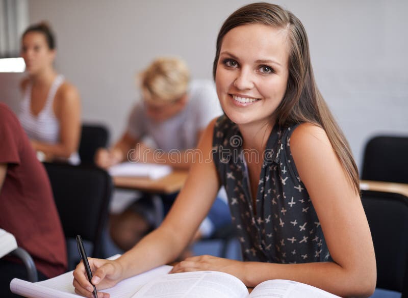Working Toward an a. an Attractive Young Varsity Student Sitting in a ...