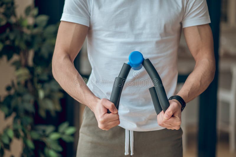 A Man in a White Tshirt Exercising with Expander Stock Photo - Image of ...