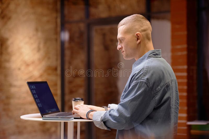 Working and Typing on Laptop in Modern Office Setting Stock Image ...