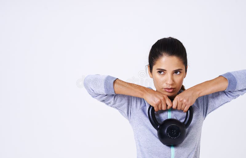 Working Up a Sweat. Studio Shot of an Attractive Young Woman Working ...