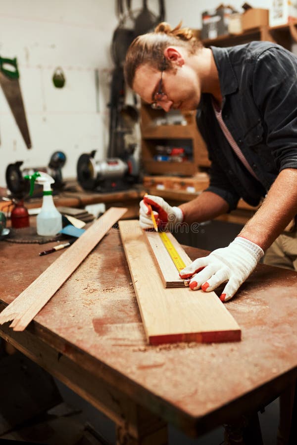 Working Very Gently. a Focused Young Carpenter Doing Measurements on a ...