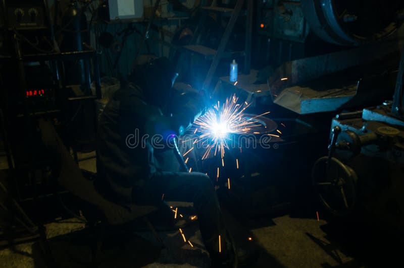 Working Welder at Work in Low Light Stock Photo - Image of labor ...