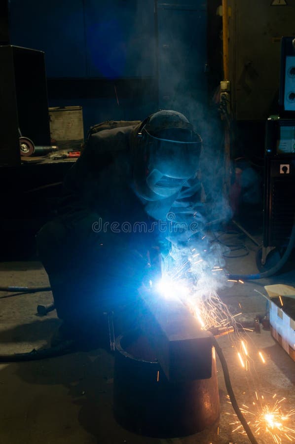 Working Welder at Work in Low Light Stock Photo - Image of labor ...