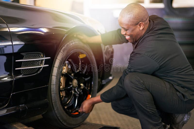 Working with Wheels. a Mechanic Repairing a Car Tyre. Stock Photo ...