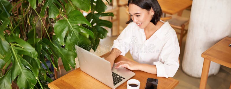 Working Woman in Cafe, Using Laptop, Studying Remotely, Freelancing ...