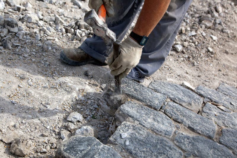 Workman breaking stones stock photo. Image of hammer - 10881950