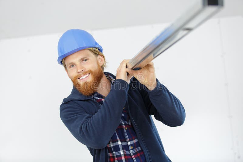 Workman Carrying Metal Frame on Shoulder Stock Image - Image of working ...