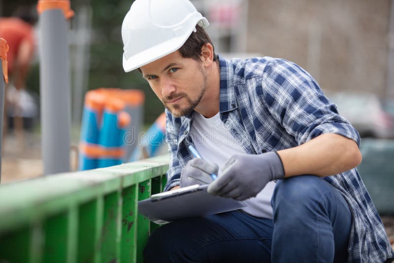 Workman Checking Site and Making Notes on Clipboard Stock Image - Image ...