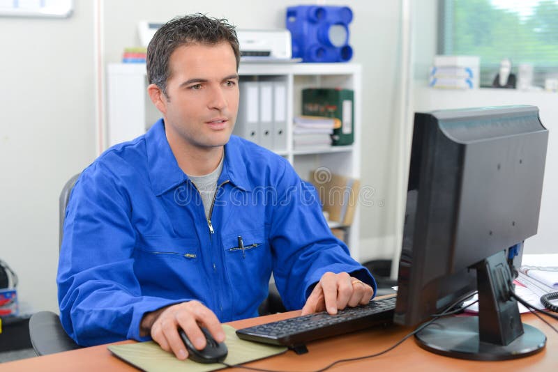 Workman on computer stock image. Image of placement - 222791689