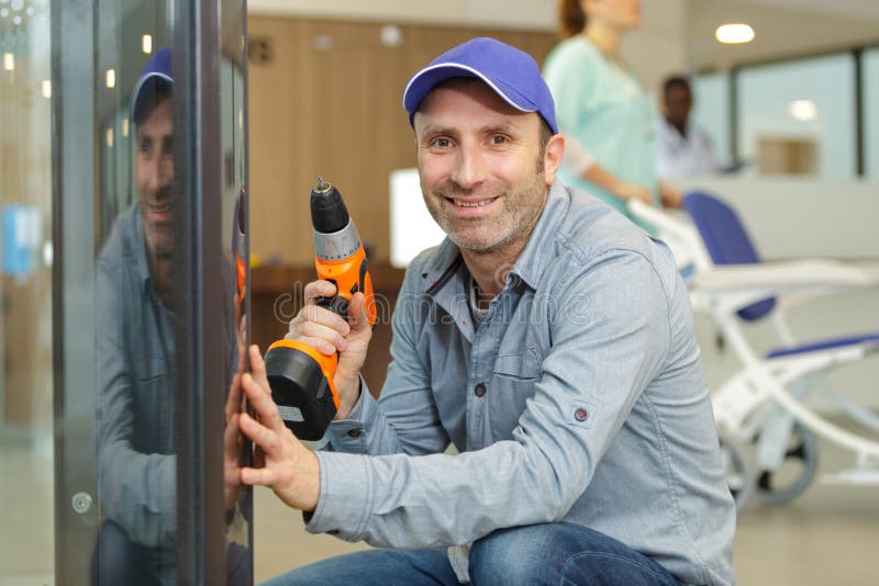 Workman Doing Maintenance in Hospital Using Cordless Drill Stock Photo ...