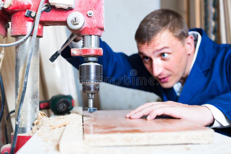 Workman drilling planks stock photo. Image of protection - 79820496