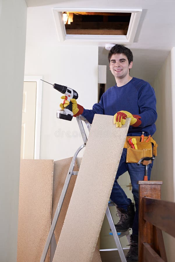 Workman Fitting Boards To Floor of House Loft Stock Photo - Image of ...