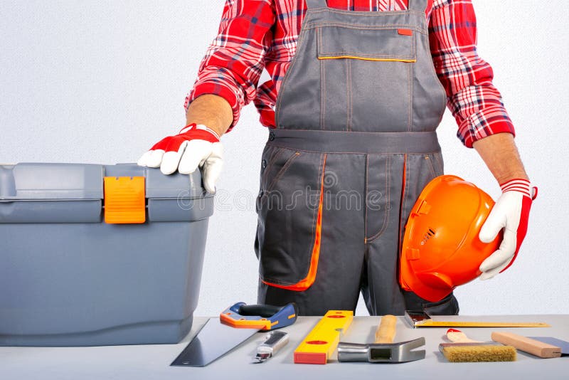 Workman in Grey Overall with Tool Box and Tools on the Table. House ...