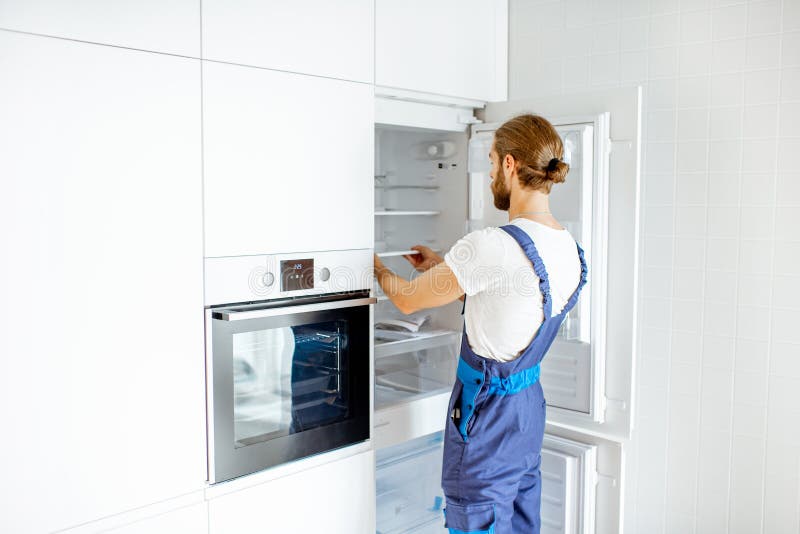 Workman Installing Fridge on the Kitchen at Home Stock Photo - Image of ...