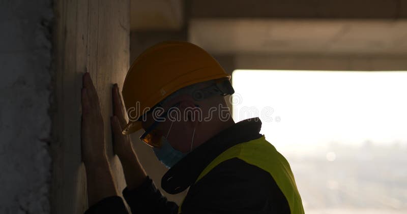 Workman Knocks His Hands and Head Against the Wall. Stressed Worker in Hard Hat Stock Footage ...