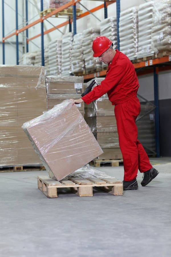 Workman Lifting Box On Pallet Stock Image - Image of cellophane, male ...
