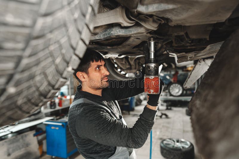 Workman Mechanic Working Under Car in Auto Repair Shop Stock Photo ...