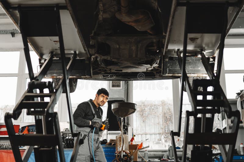 Workman Mechanic Working Under Car in Auto Repair Shop Stock Photo ...
