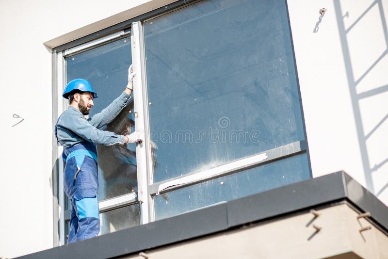 Workman mounting windows stock image. Image of reflection - 131229239