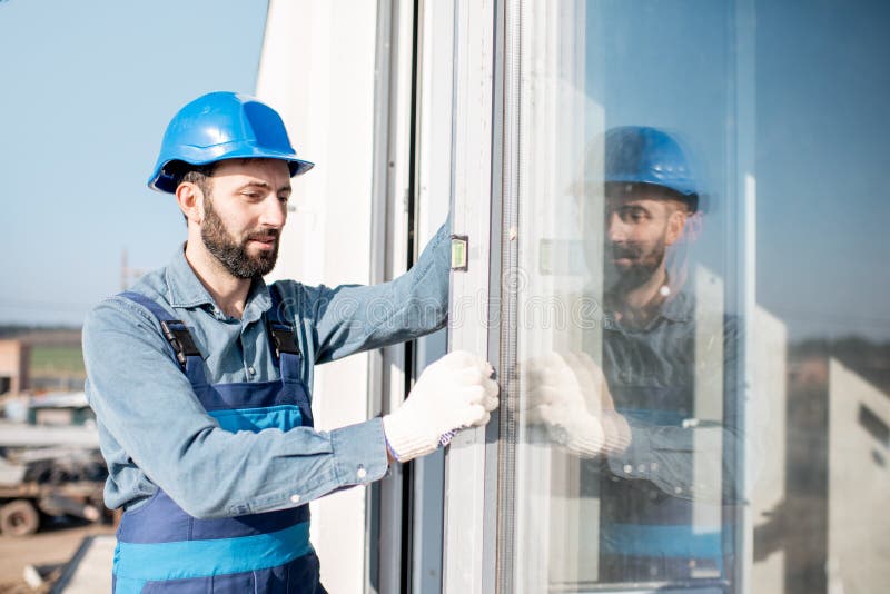 Workman mounting windows stock image. Image of mounter - 131229171