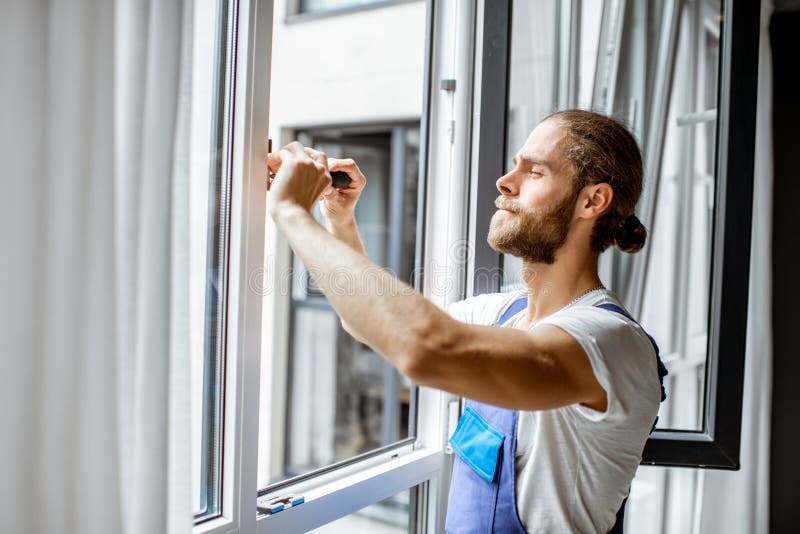 Workman Adjusting Window Frames at Home Stock Photo - Image of windows ...