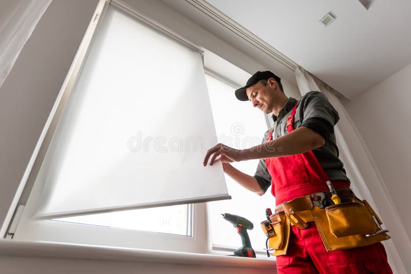 Workman in Overalls Installing or Adjusting Plastic Windows in the Living Room at Home Stock ...