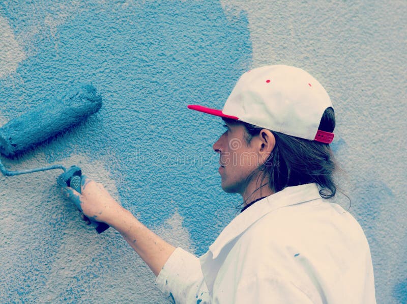 Workman painting the wall stock image. Image of painter - 109641657