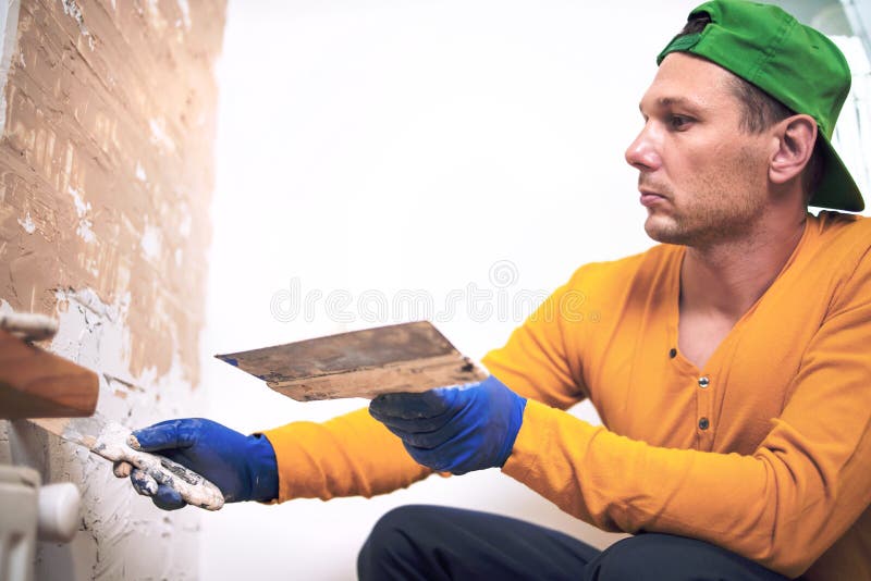 Building Under Construction with Bricklayer Plastering Concrete To ...