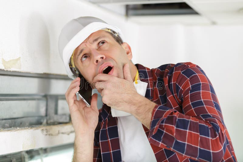 Workman in Property Looking Up in Dismay Stock Image - Image of person ...
