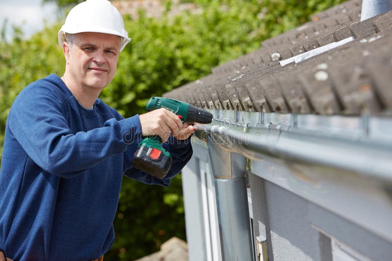 Workman Replacing Guttering on Exterior of House Stock Photo - Image of ...